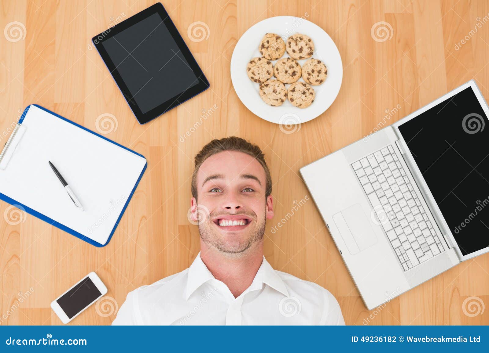 Man Lying on Floor Surrounded by Various Objects at Home Stock Photo ...