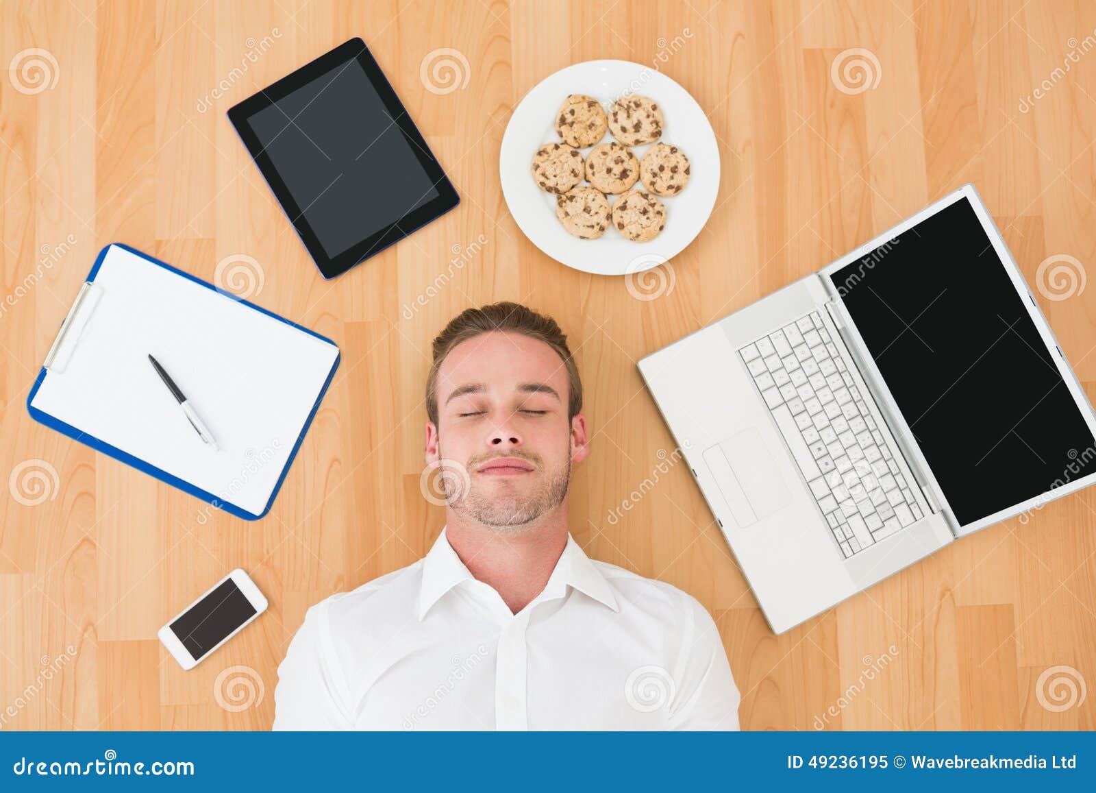 Man Lying on Floor Surrounded by Various Objects at Home Stock Image ...