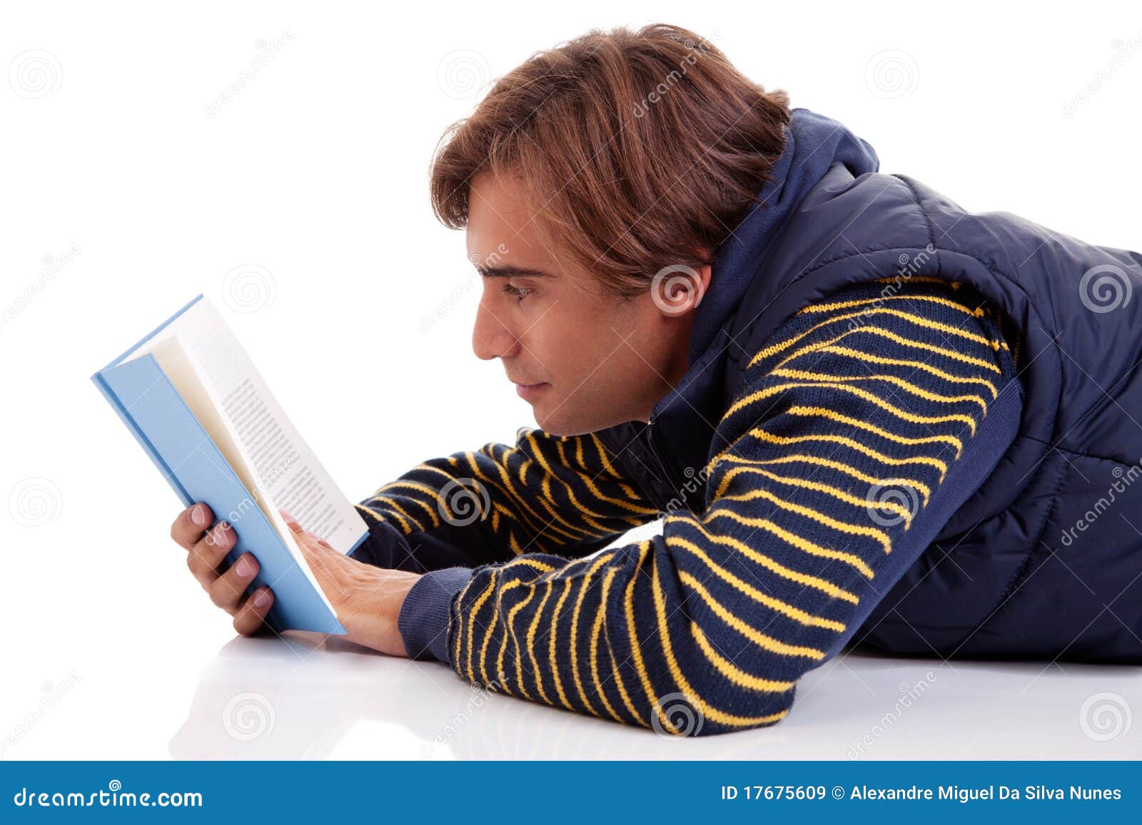 Man lying reading a book stock image. Image of young - 17675609