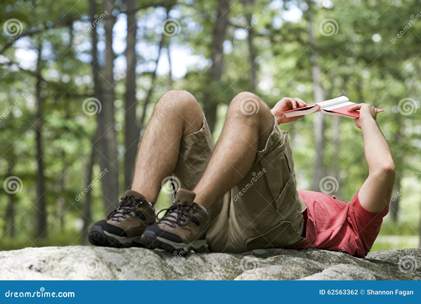 Man Lying on a Rock Reading a Book Stock Photo - Image of activity ...