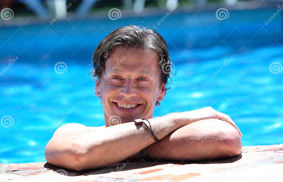 Man Lying on Side of Swimming Pool in the Sun Stock Photo - Image of ...