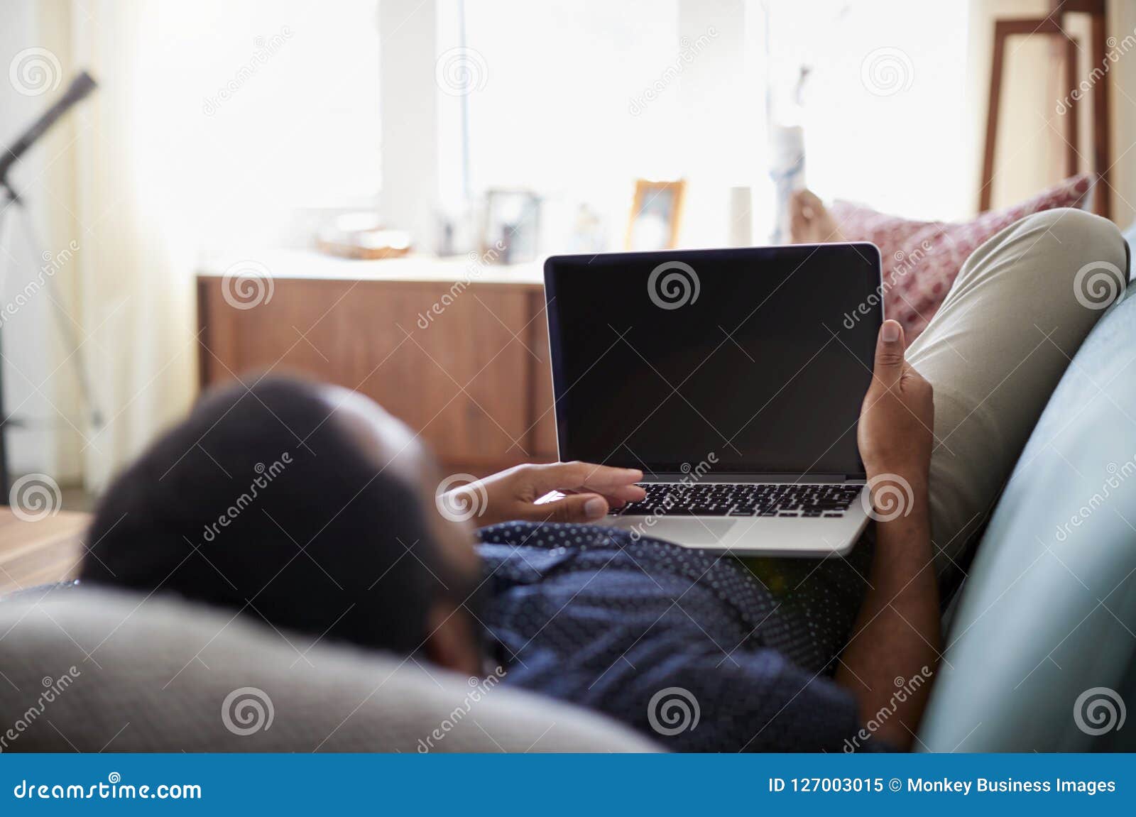 Man Lying on Sofa at Home Using Laptop Computer Stock Image - Image of ...