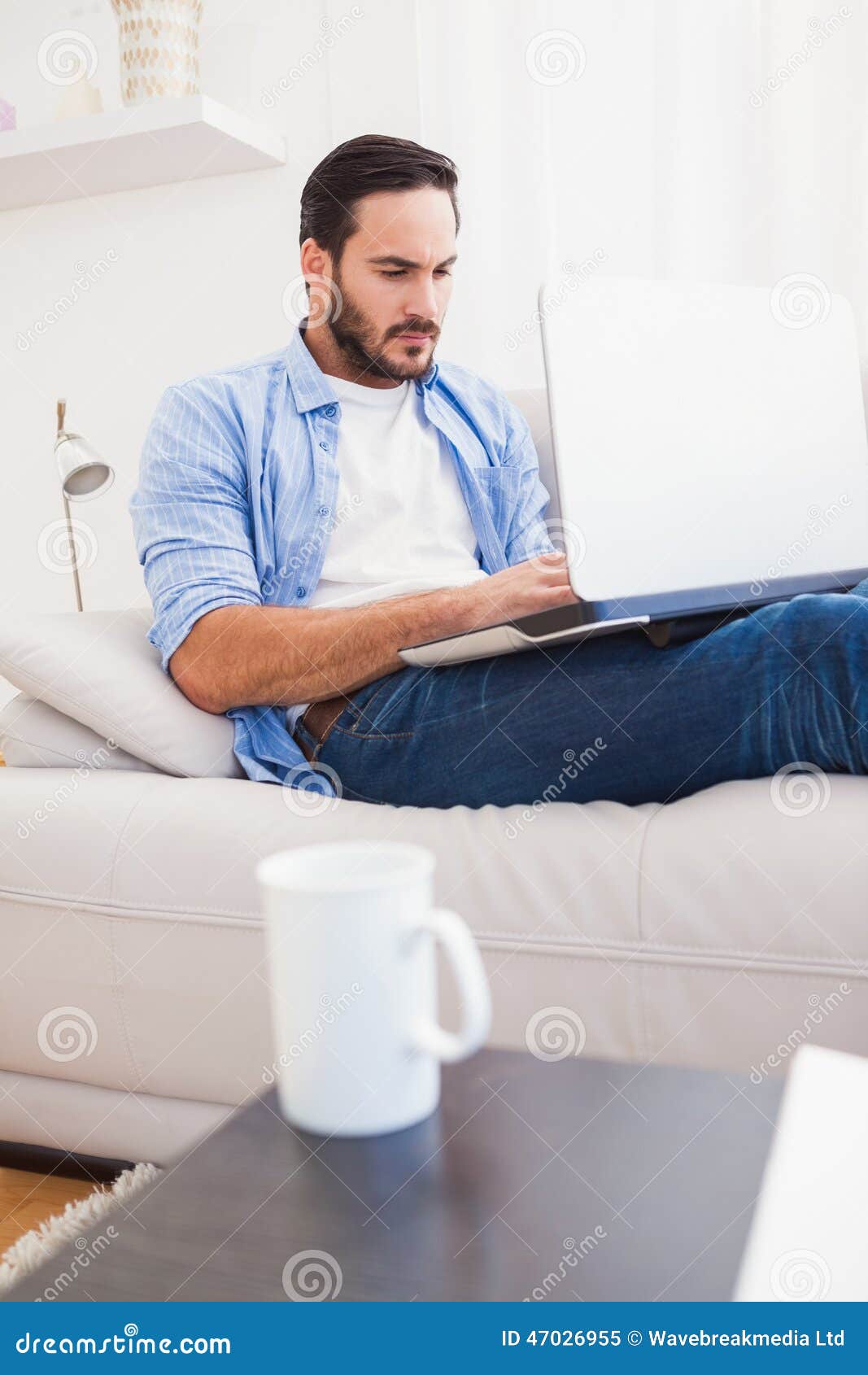 Man Lying on Sofa Using Laptop Stock Image - Image of laptop, house ...