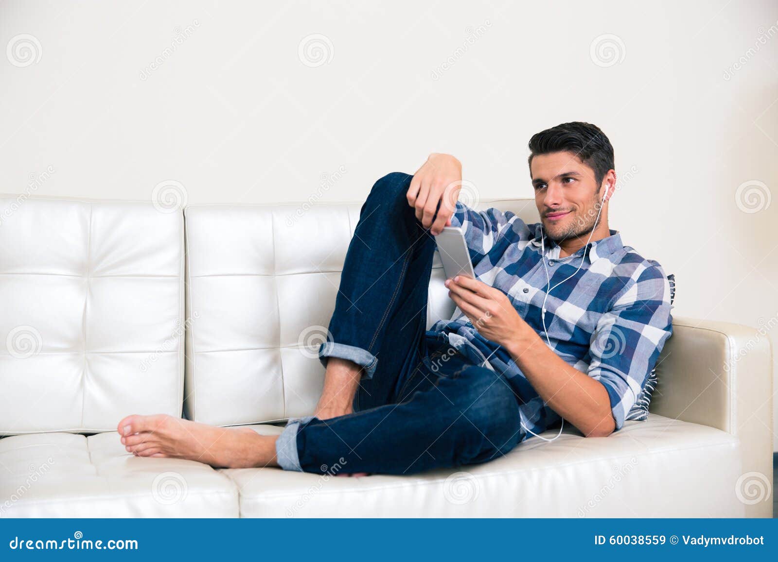 Man Lying on the Sofa and Using Smartphone Stock Image - Image of ...