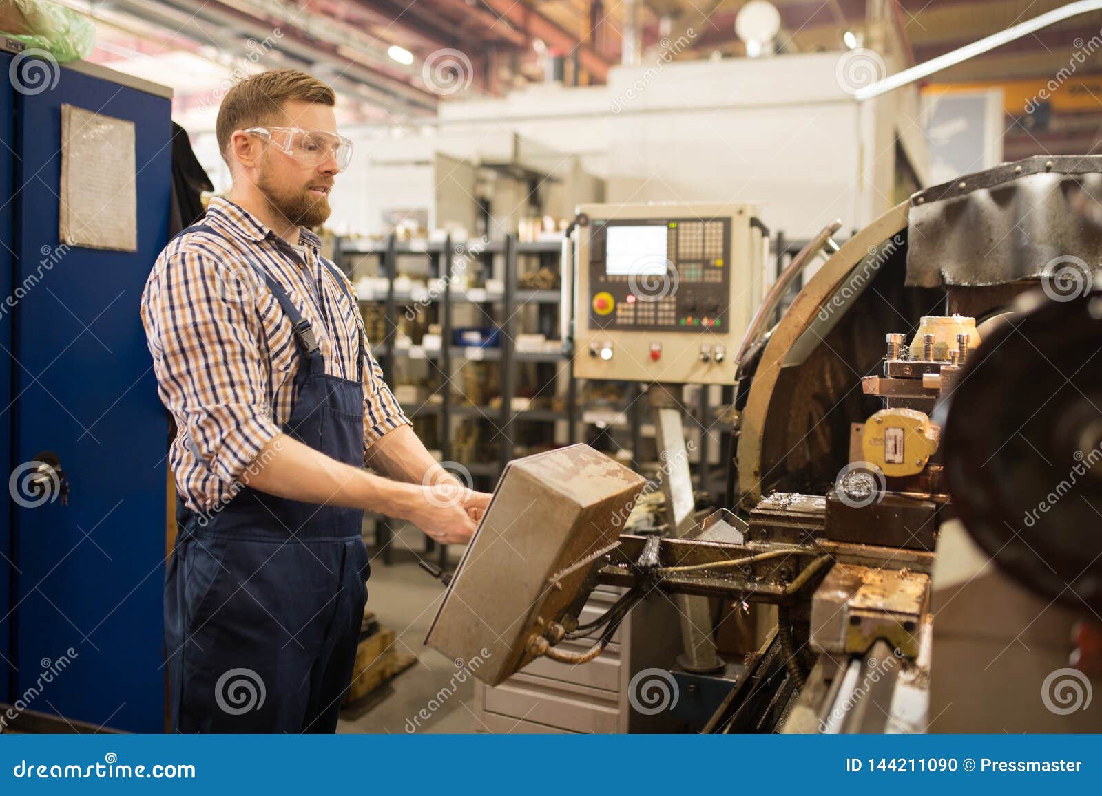 Man by machine stock photo. Image of overalls, manufacturing - 144211090