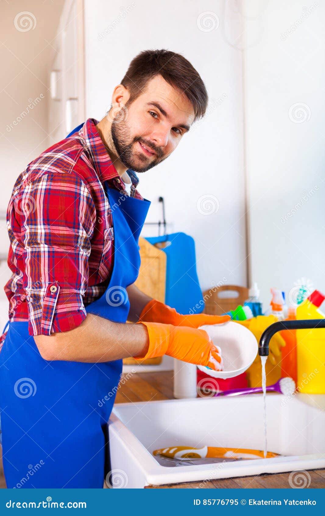 Man Makes Cleaning the Kitchen. Young Man Washes the Dishes. Cleaning ...