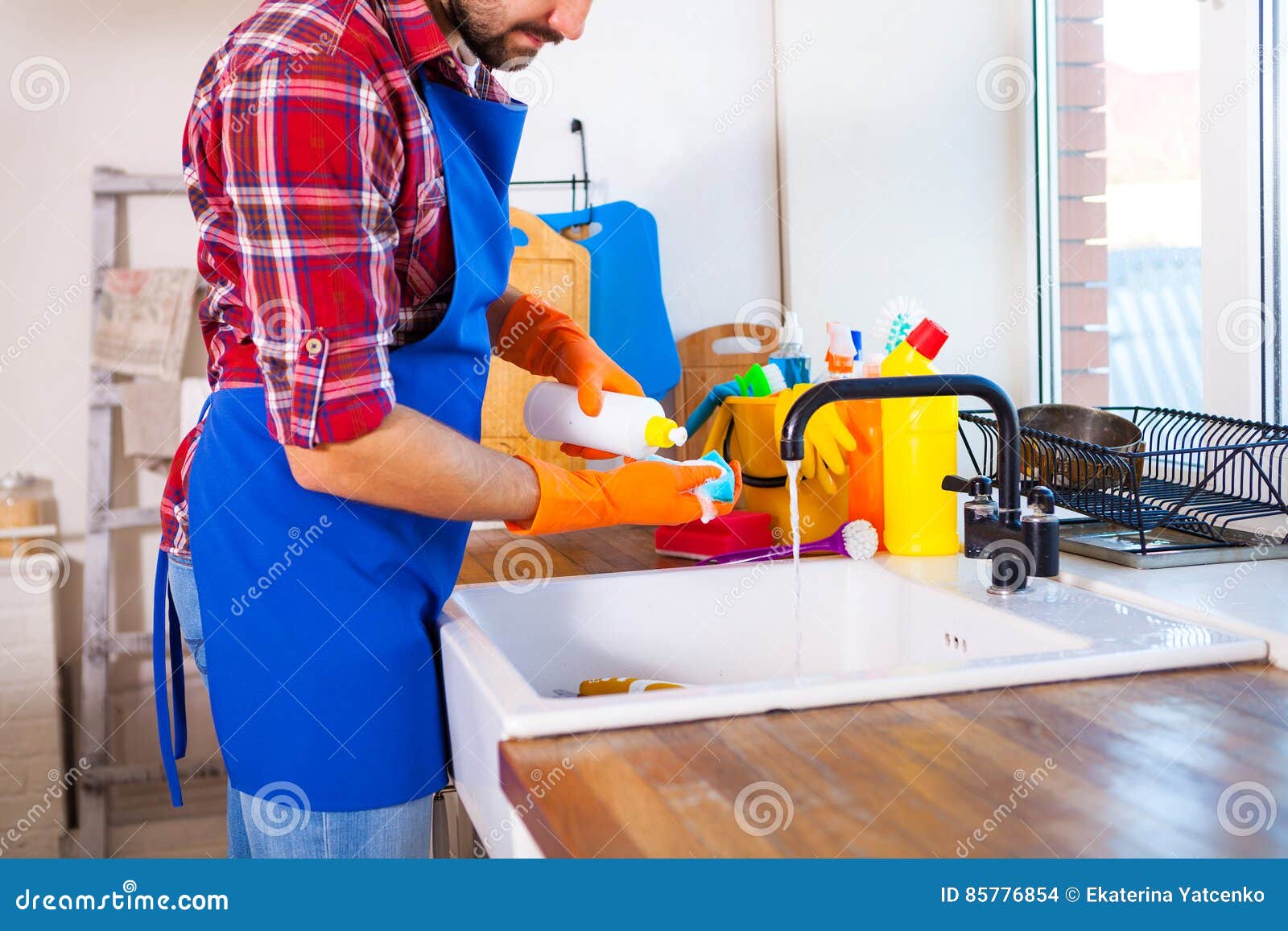 Man Makes Cleaning the Kitchen. Young Man Washes the Dishes. Cleaning ...