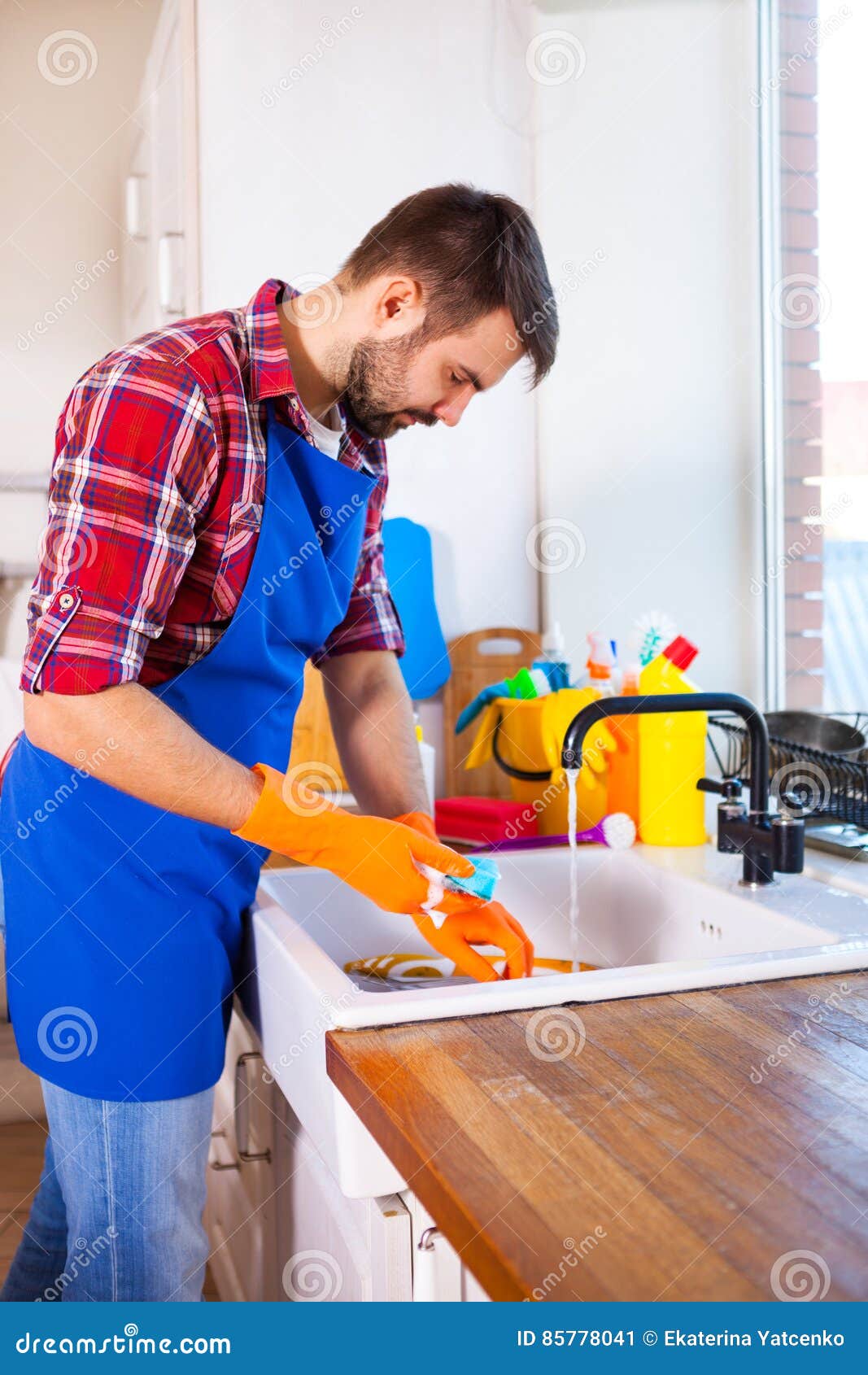 Man Makes Cleaning the Kitchen. Young Man Washes the Dishes. Cleaning ...