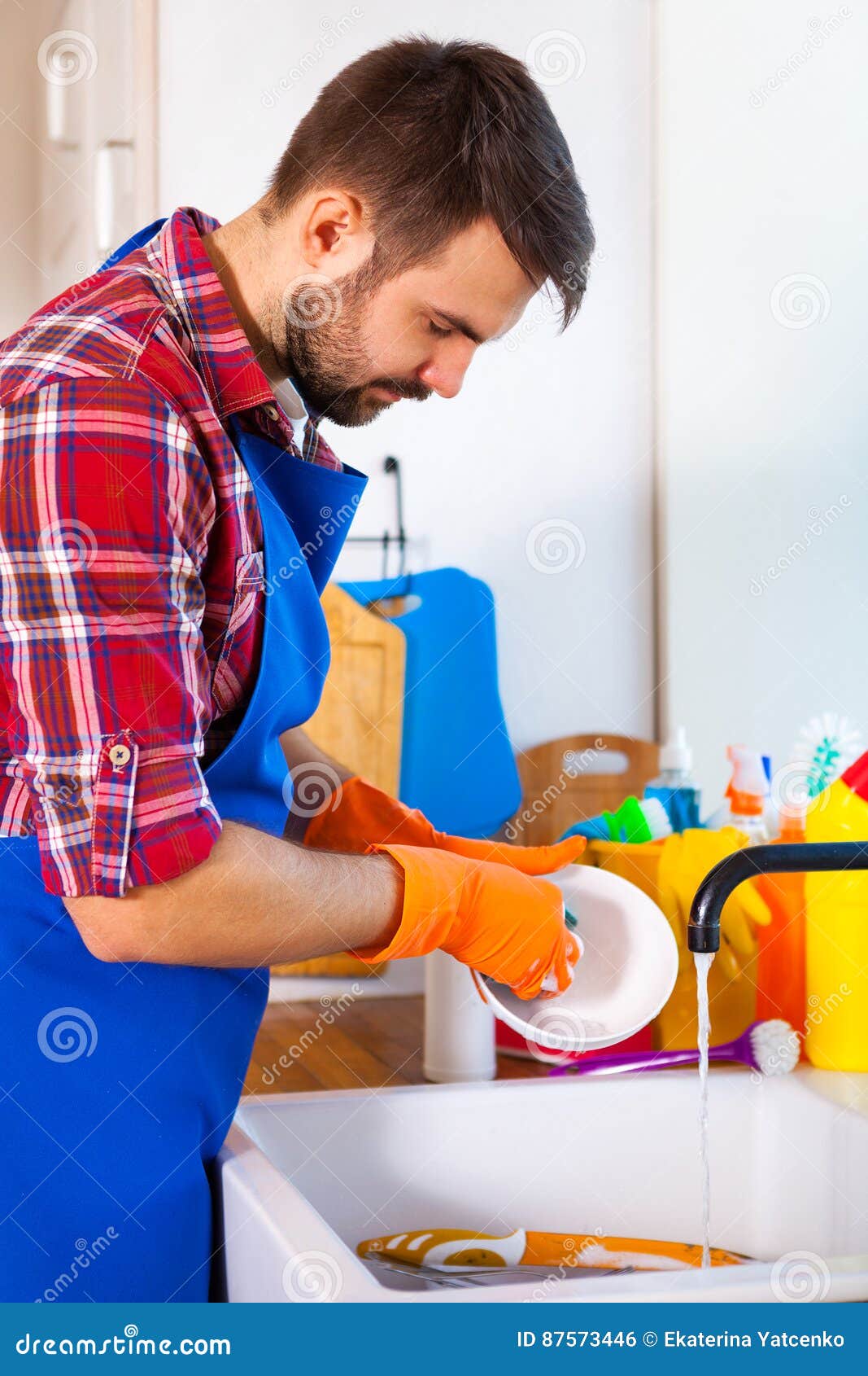 Man Makes Cleaning the Kitchen. Young Man Washes the Dishes. Cleaning ...
