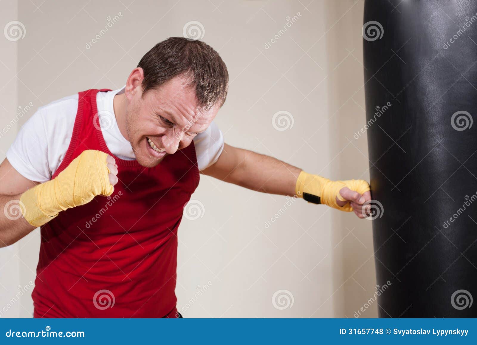 Man Makes Exercises with Punching Bag Stock Photo - Image of people ...
