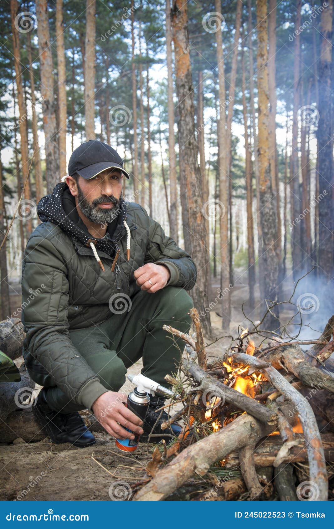 A Man Makes a Fire in the Forest with a Lighter. Close-up of a Man ...