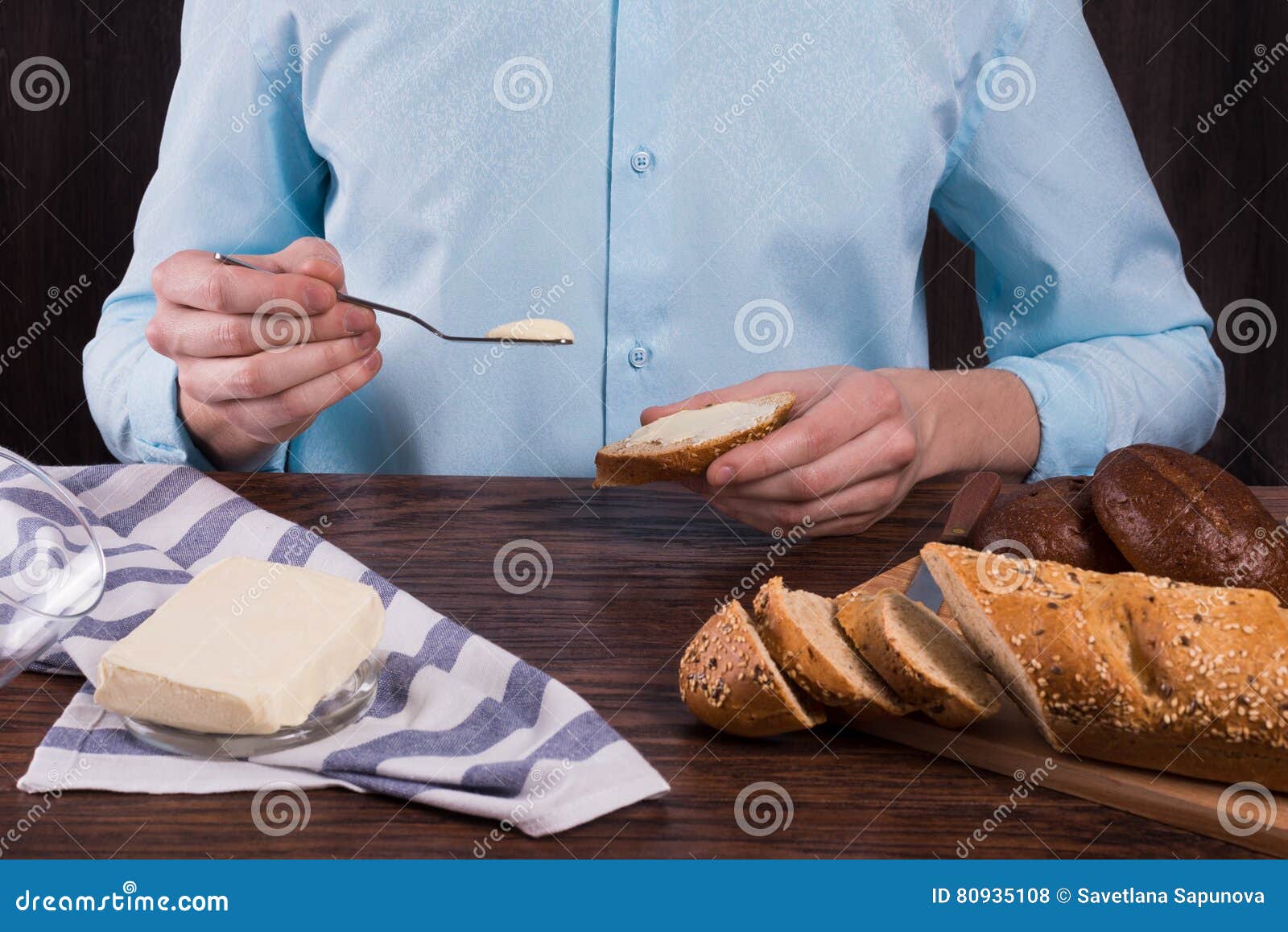 Man Makes a Toast with Butter Stock Photo - Image of hands, cropped ...