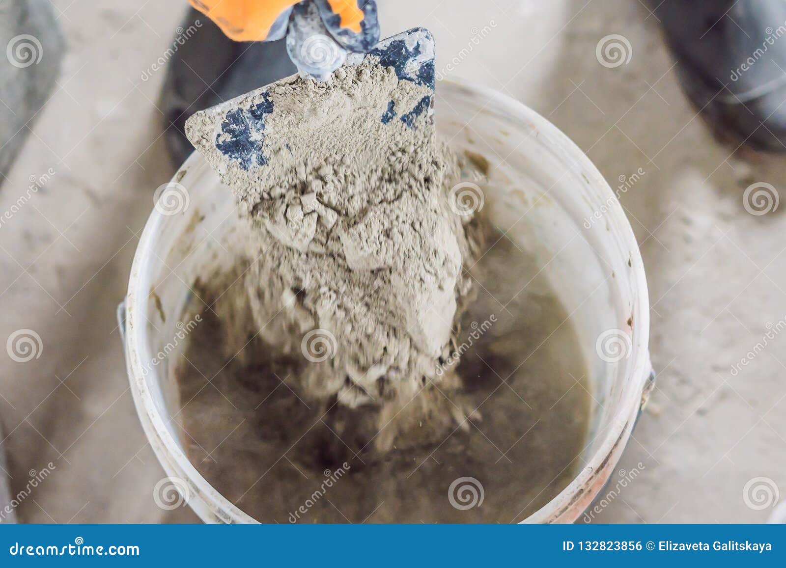 Man Making Cement with a Construction Mixer in a Bucket Stock Photo ...