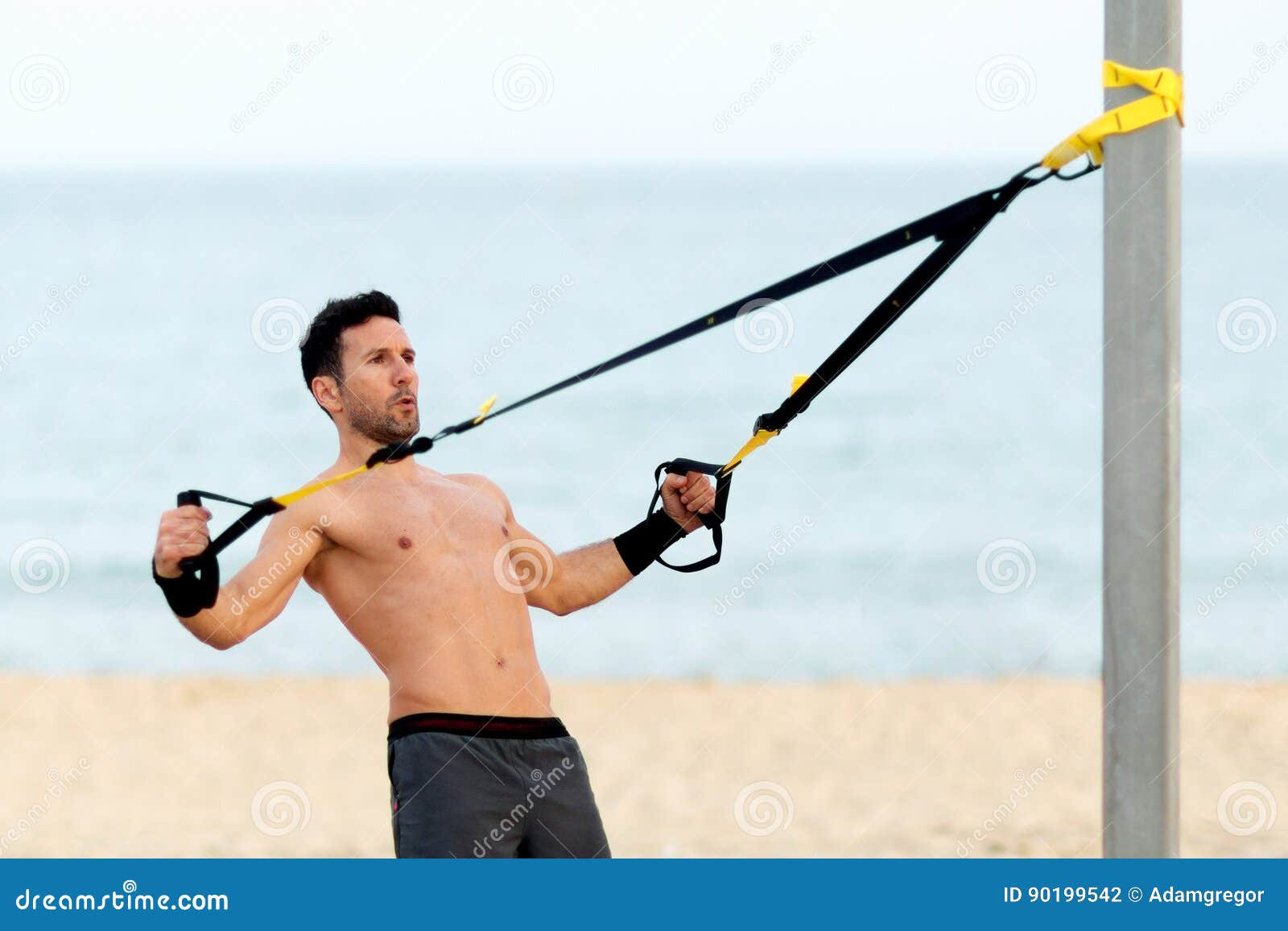Man Making Chest Trx Exercise on the Beach Stock Photo - Image of beach ...