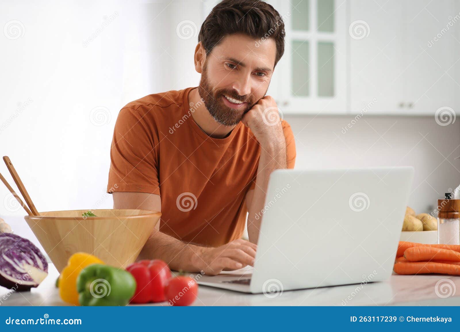 Man Making Dinner while Watching Online Cooking Course Via Laptop in ...
