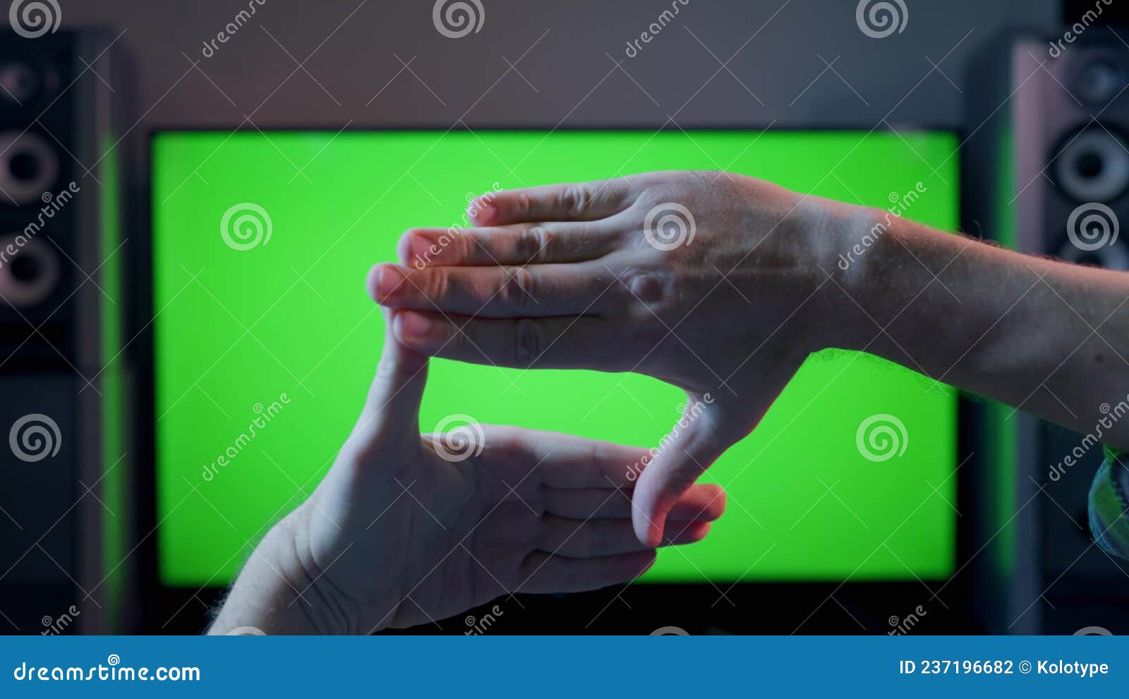 Man Making a Frame Gesture with His Hands Against a TV Screen Stock ...