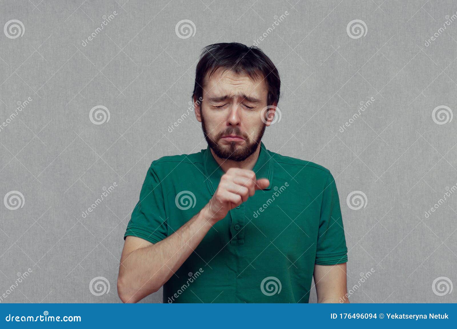 Man Making a Funny Face while Coughing into His Hand Stock Photo ...