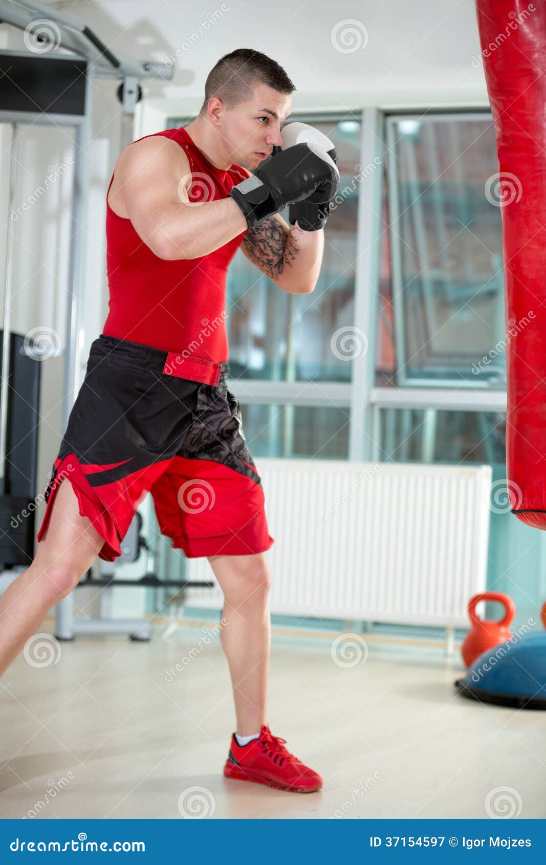 Man Making a Hard Punch on a Bag Stock Image - Image of gloves, extreme ...