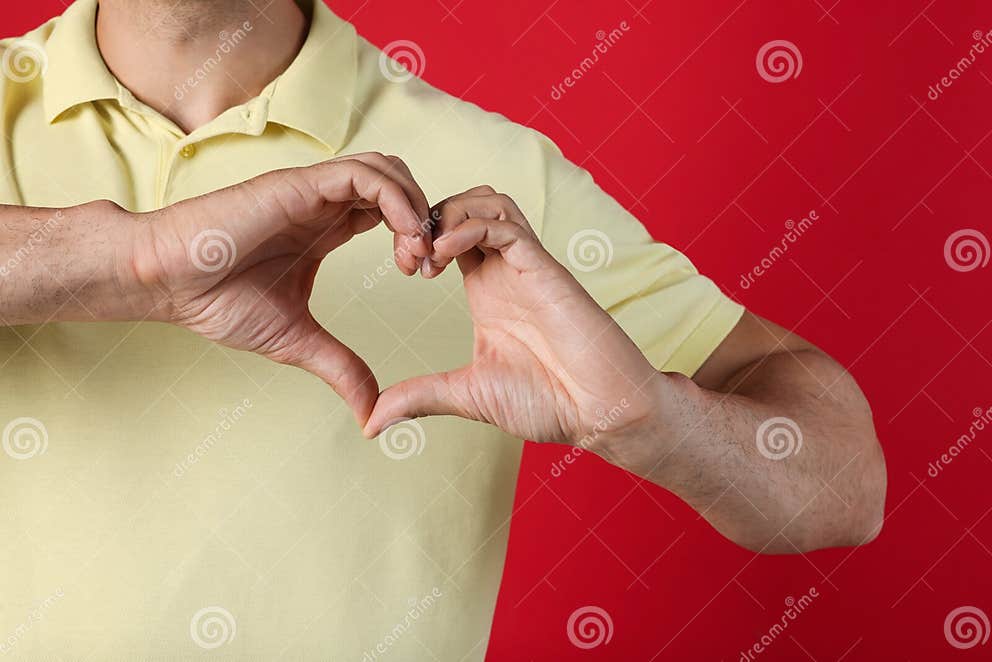 Man Making Heart with Hands on Red Background, Closeup Stock Photo ...