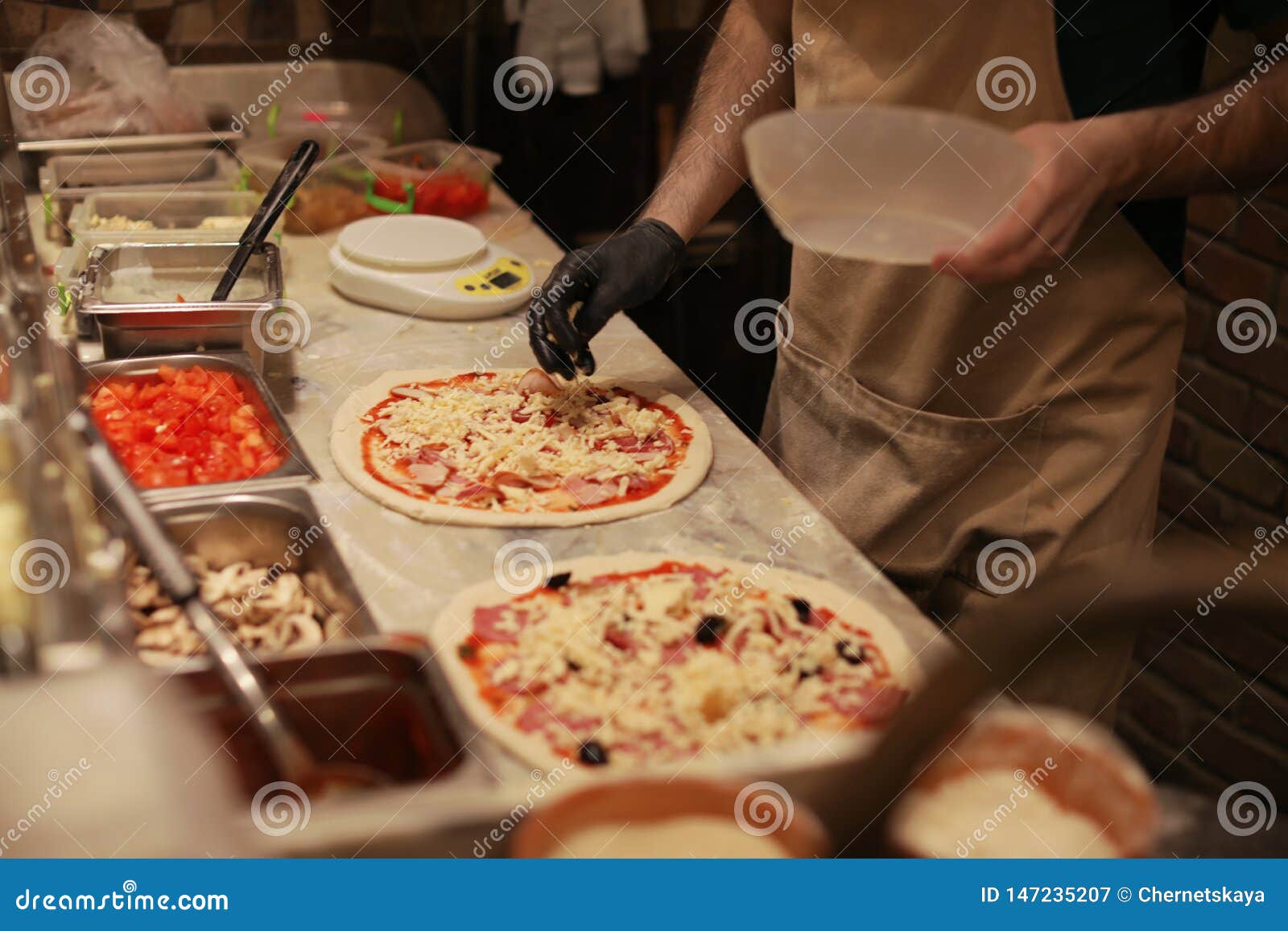 Man making pizzas at table stock image. Image of fast - 147235207