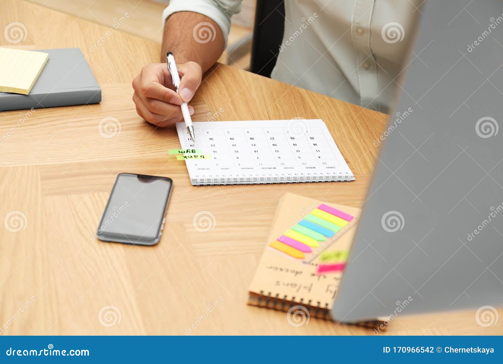 Man Making Schedule Using Calendar at Table in Office Stock Photo ...