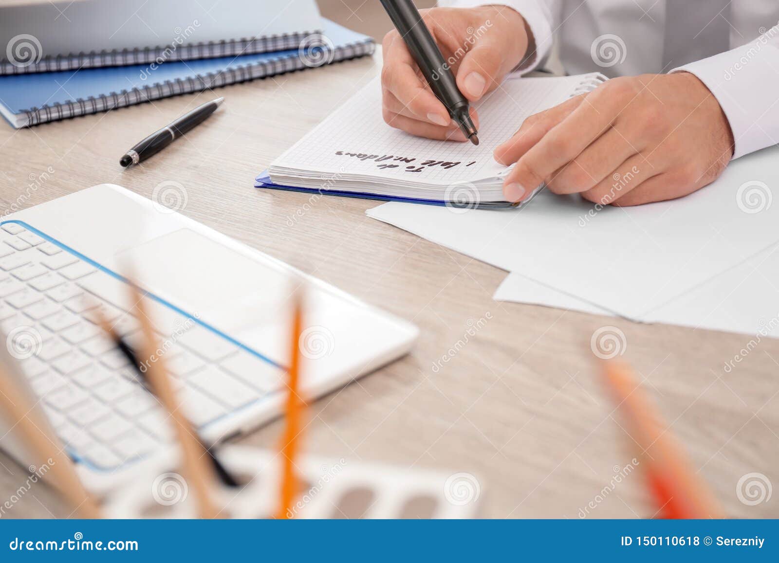 Man Making To-do List while Sitting at Table Stock Photo - Image of ...