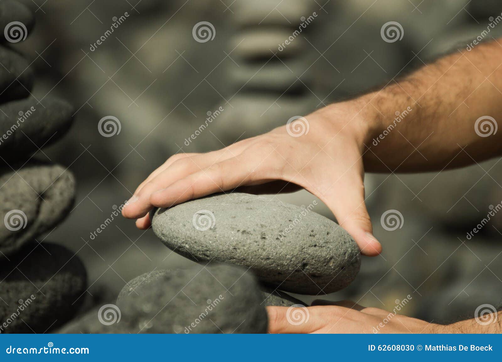 Man Making a Tower with Stones Stock Photo - Image of working, beach ...