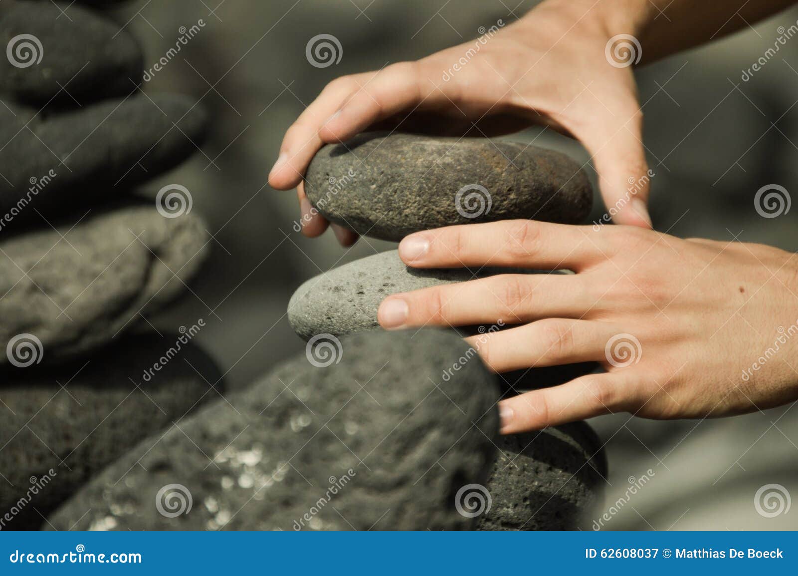 Man Making a Tower with Stones Stock Image - Image of improving, beach ...