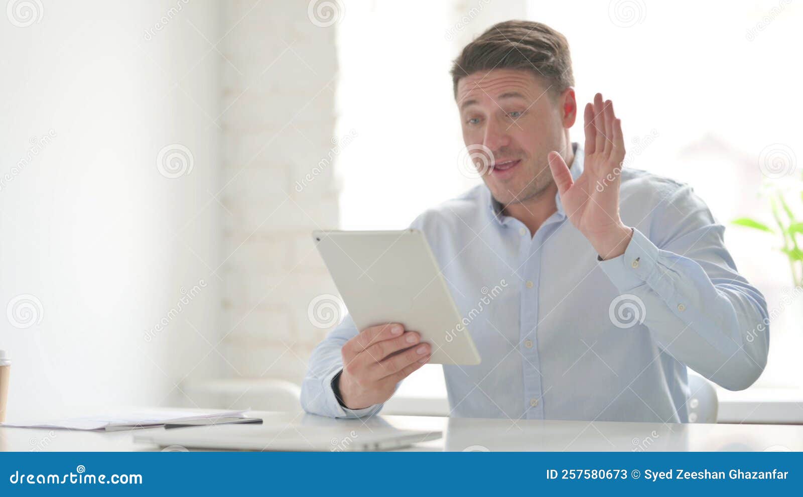 Man Making Video Call on Tablet in Office Stock Image - Image of ...