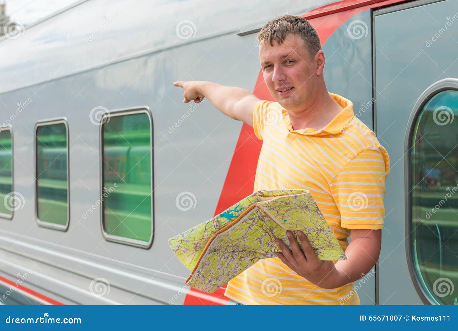 Man with a Map Shows the Direction of the Train Station Stock Image ...