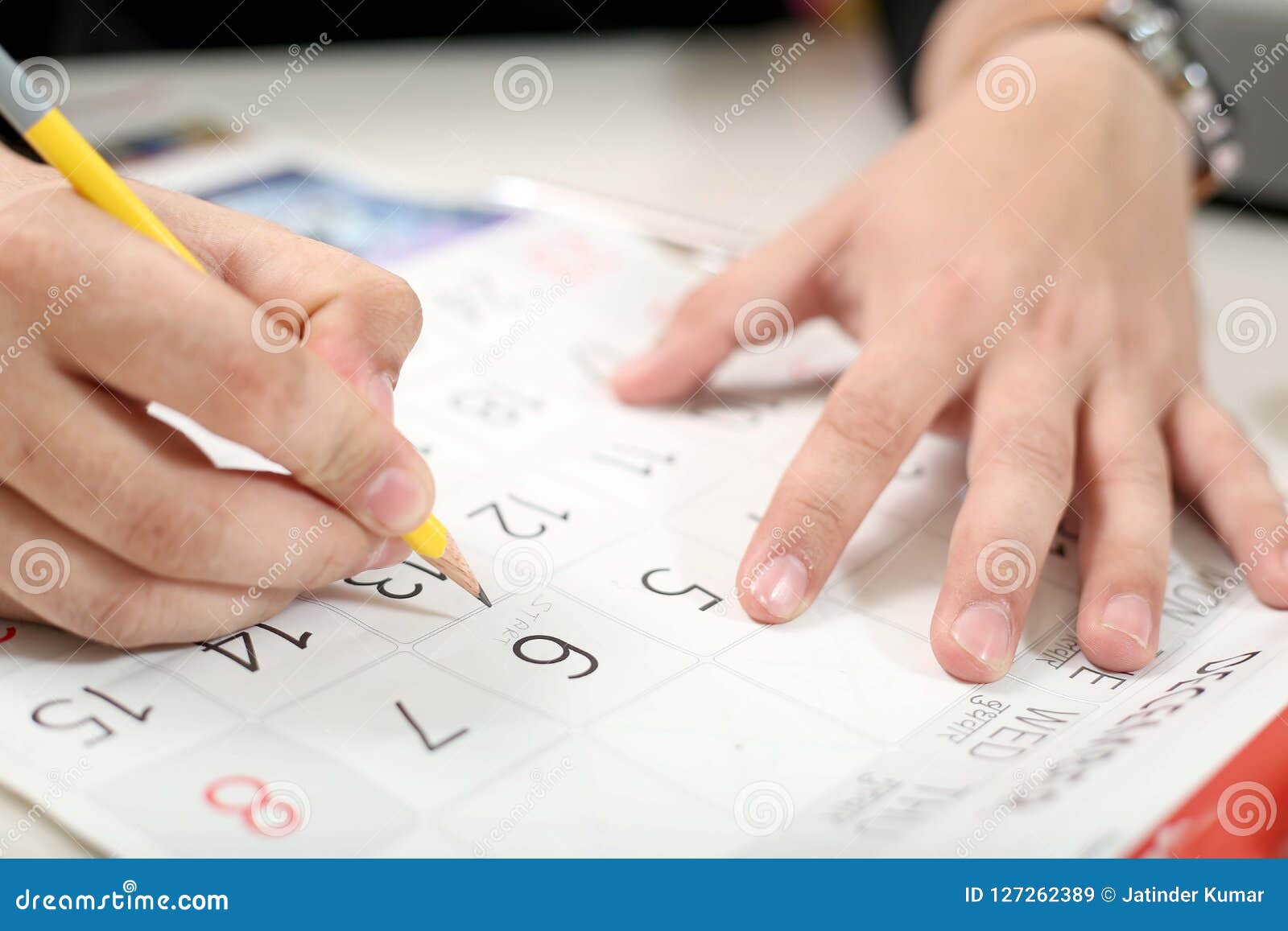 Man is Marking Date on Calendar for Schedule with Pencil Stock Image ...
