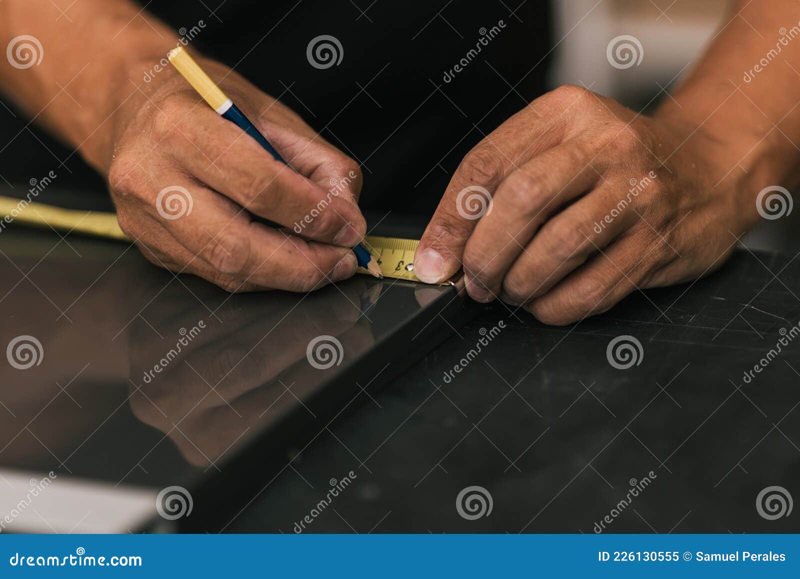 Man Marking a Surface Using a Meter in a Workshop Stock Image - Image ...