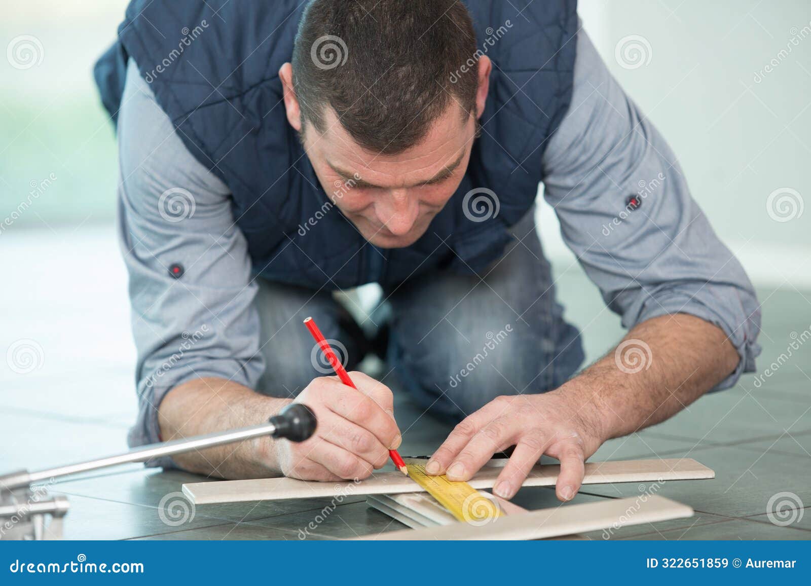Man marking tile to be cut stock image. Image of measurement - 322651859