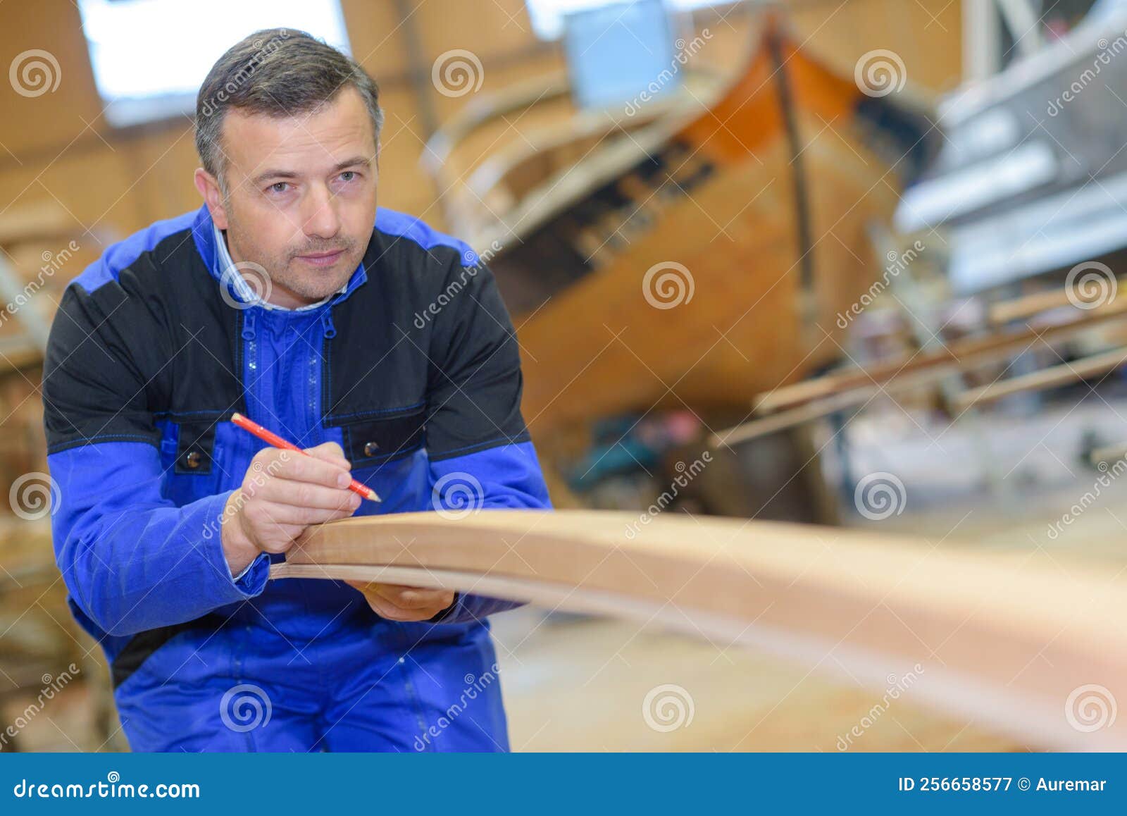 Man marking wooden block stock image. Image of work - 256658577