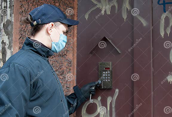 A Man in a Mask and Gloves Opens the Intercom with a Key Stock Photo ...
