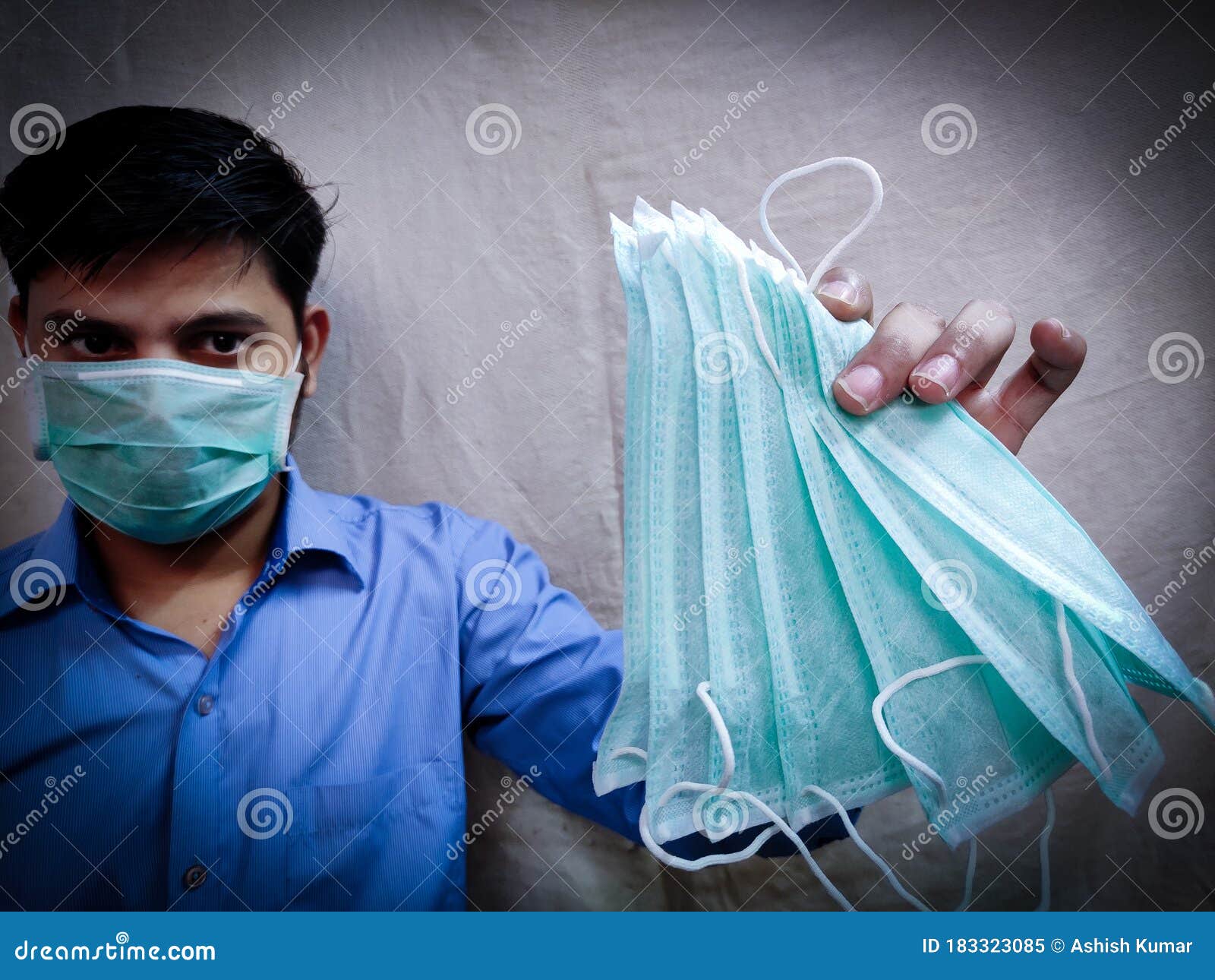 Man in Mask Hold Surgical Face Mask Bunch in Stretch Hand. Stock Image ...