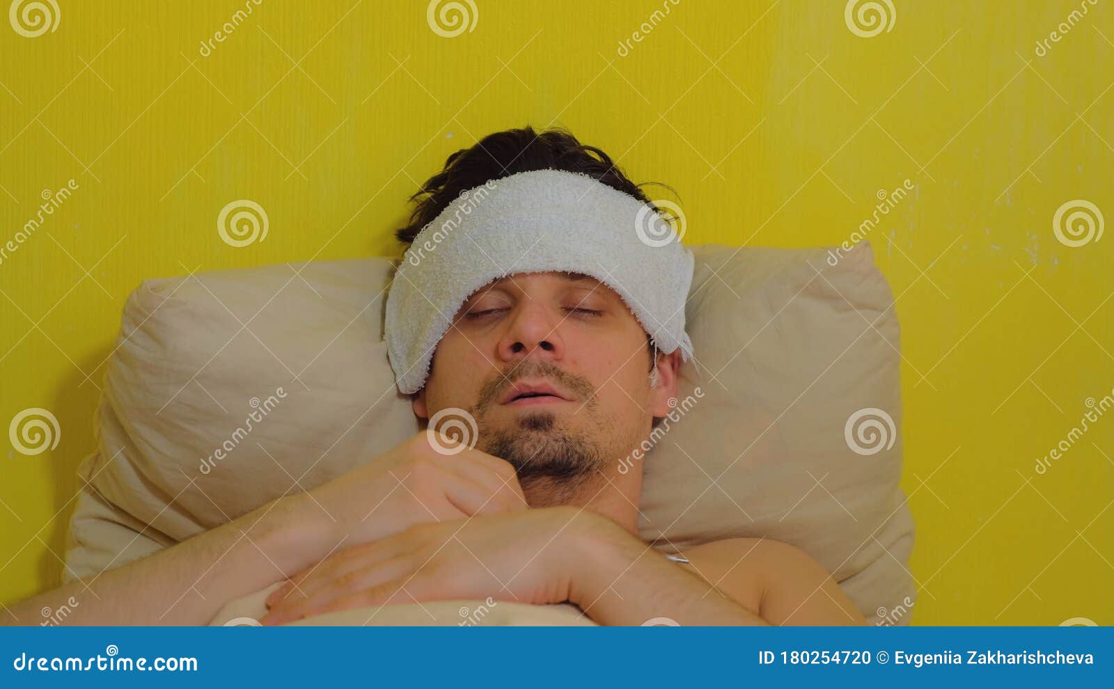 Man Measures Body Temperature Using Thermometer and Puts Wet Towel on ...