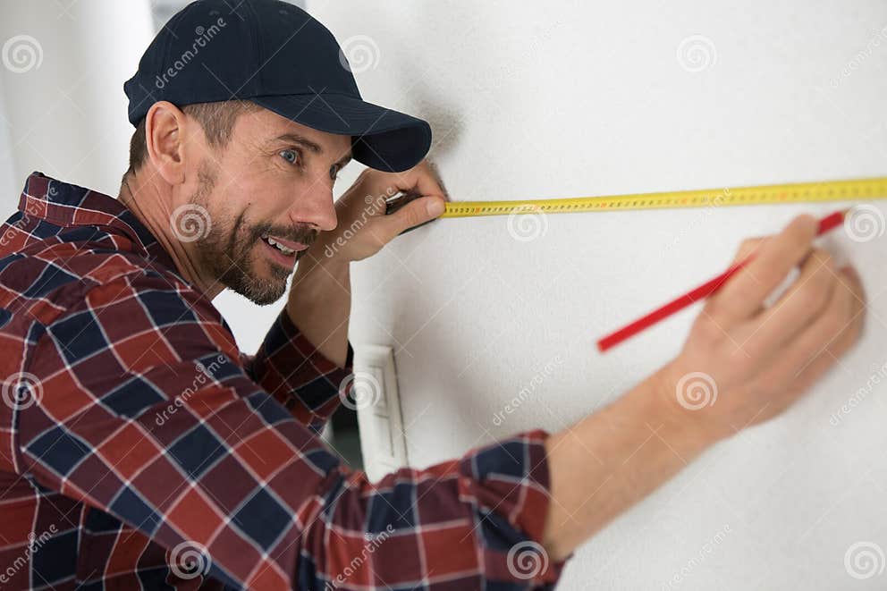 Man Measures Wall with Ruler Stock Photo - Image of home, builder ...