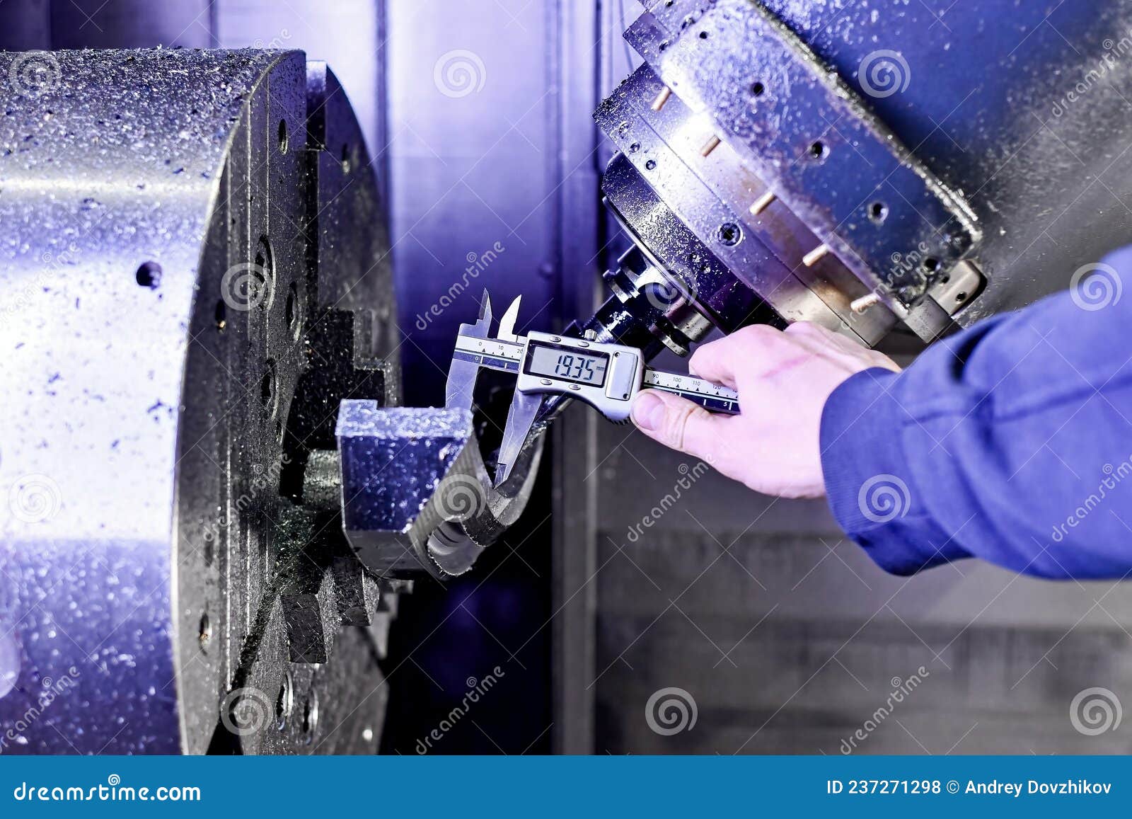 A Man Measures a Workpiece with a Digital Caliper on a CNC Milling ...
