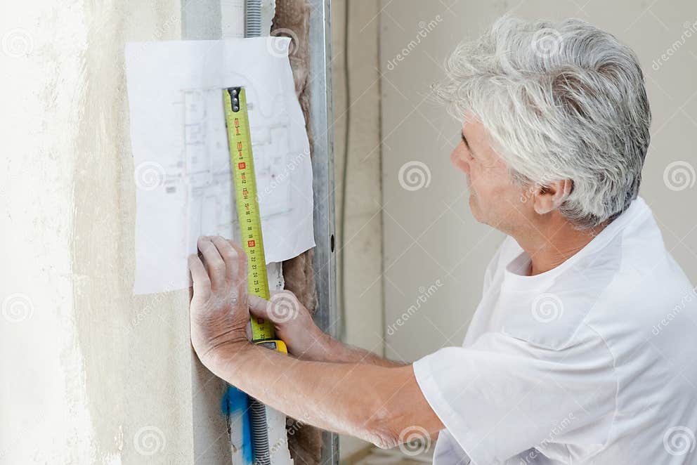 Man measuring on blueprint stock image. Image of draft - 101435863