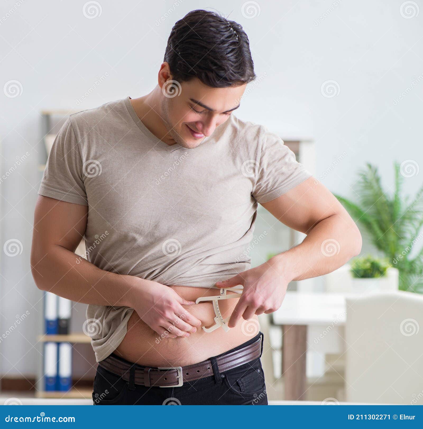 Man Measuring Body Fat with Calipers Stock Image - Image of belly ...