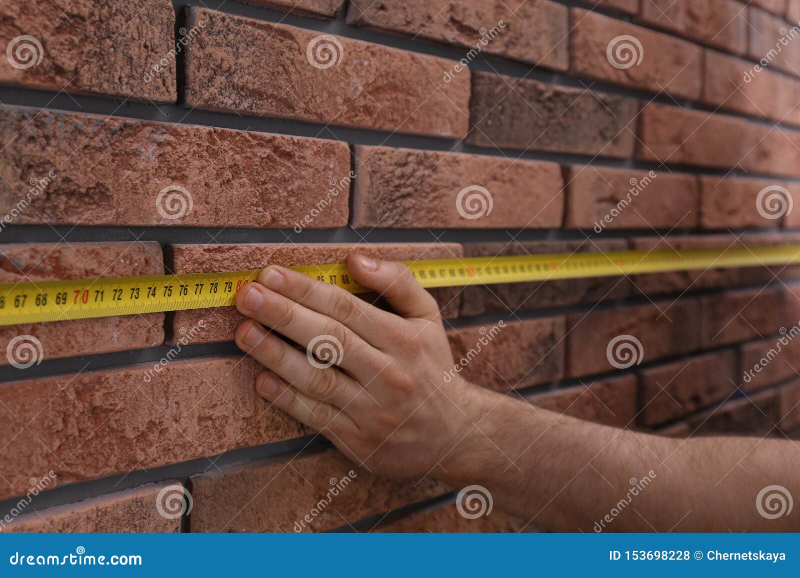 Man Measuring Brick Wall. Construction Tool Stock Photo - Image of ...