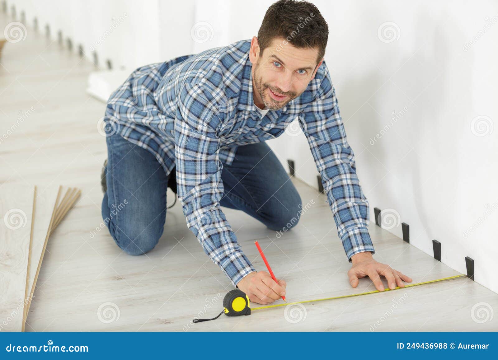 Man measuring floor board stock photo. Image of indoor - 249436988