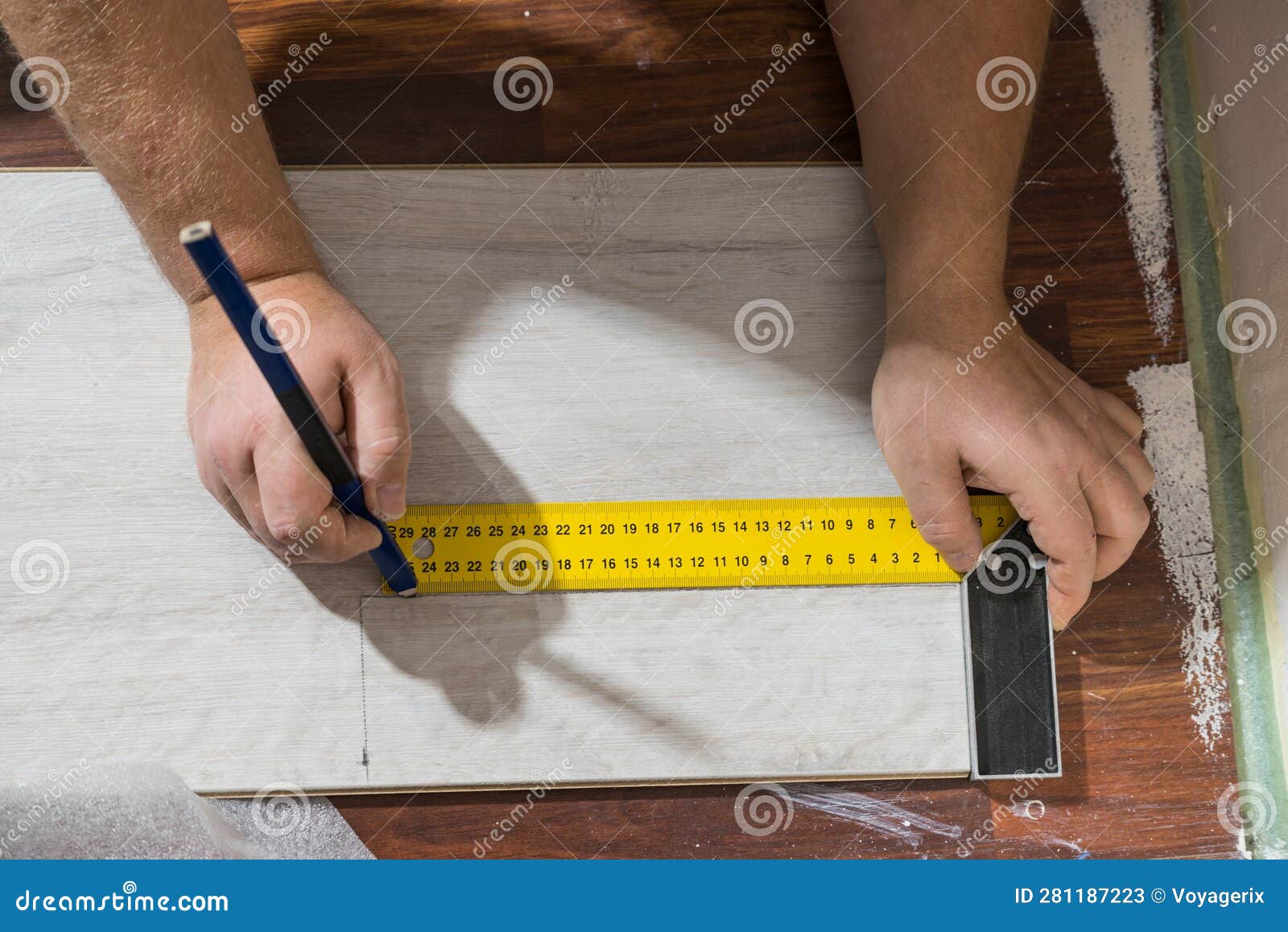 Man measuring floor panels stock image. Image of room - 281187223