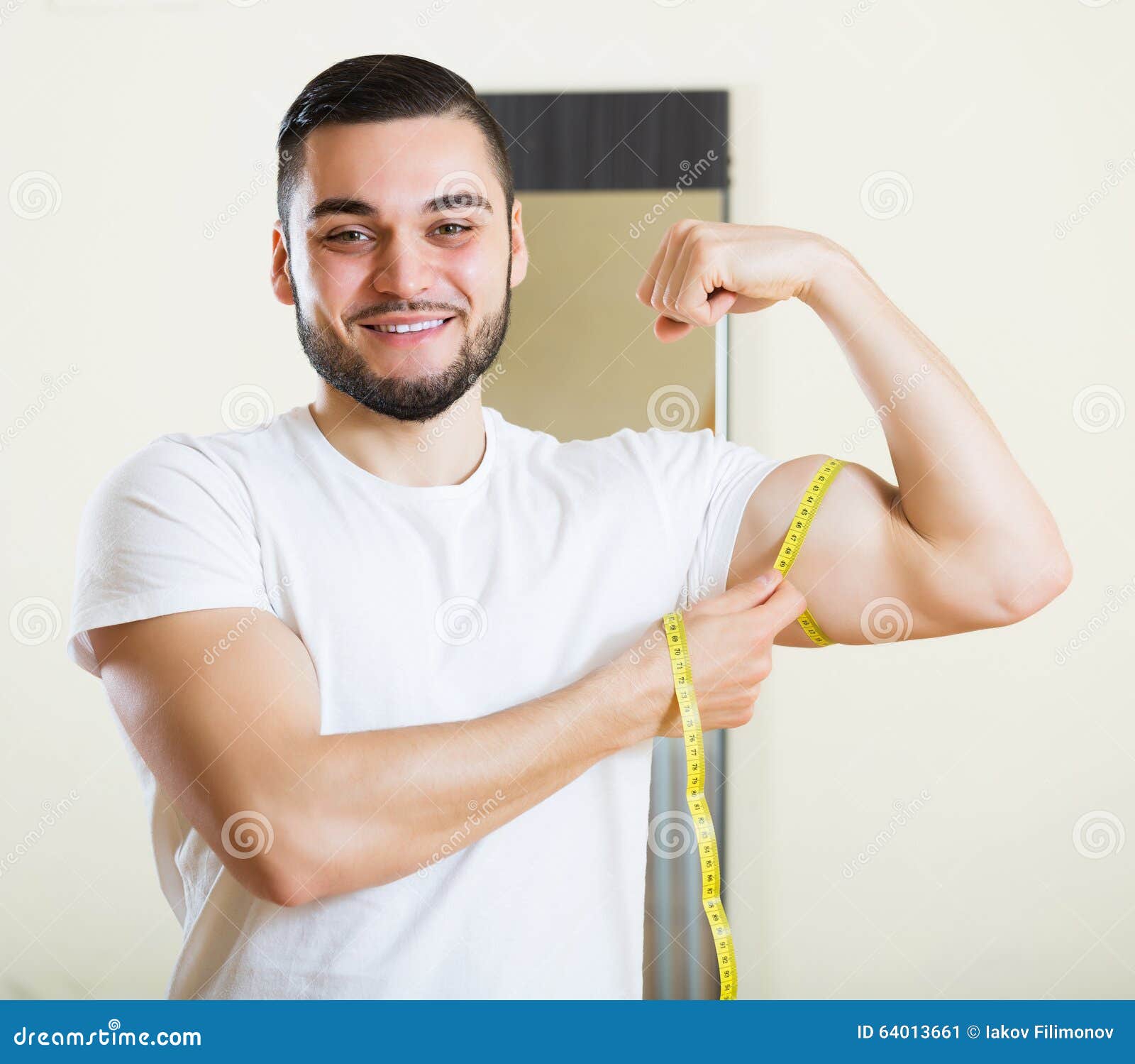 Man measuring his bicep stock image. Image of clothing - 64013661