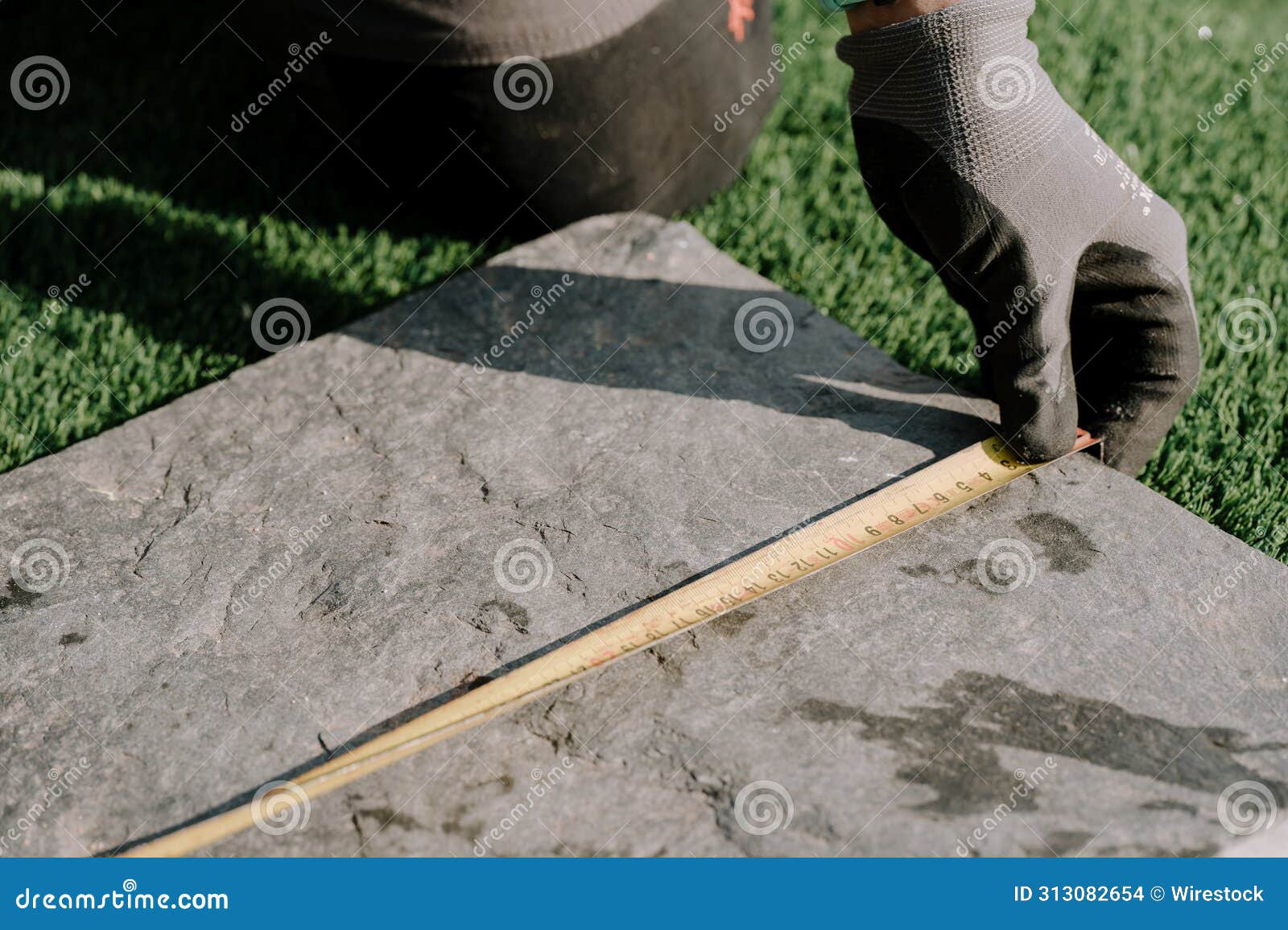 Man Measuring the Length of a Rock on the Ground Stock Photo - Image of ...