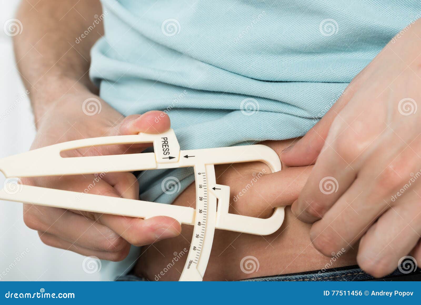 Man Measuring Stomach Fat stock photo. Image of measure - 77511456