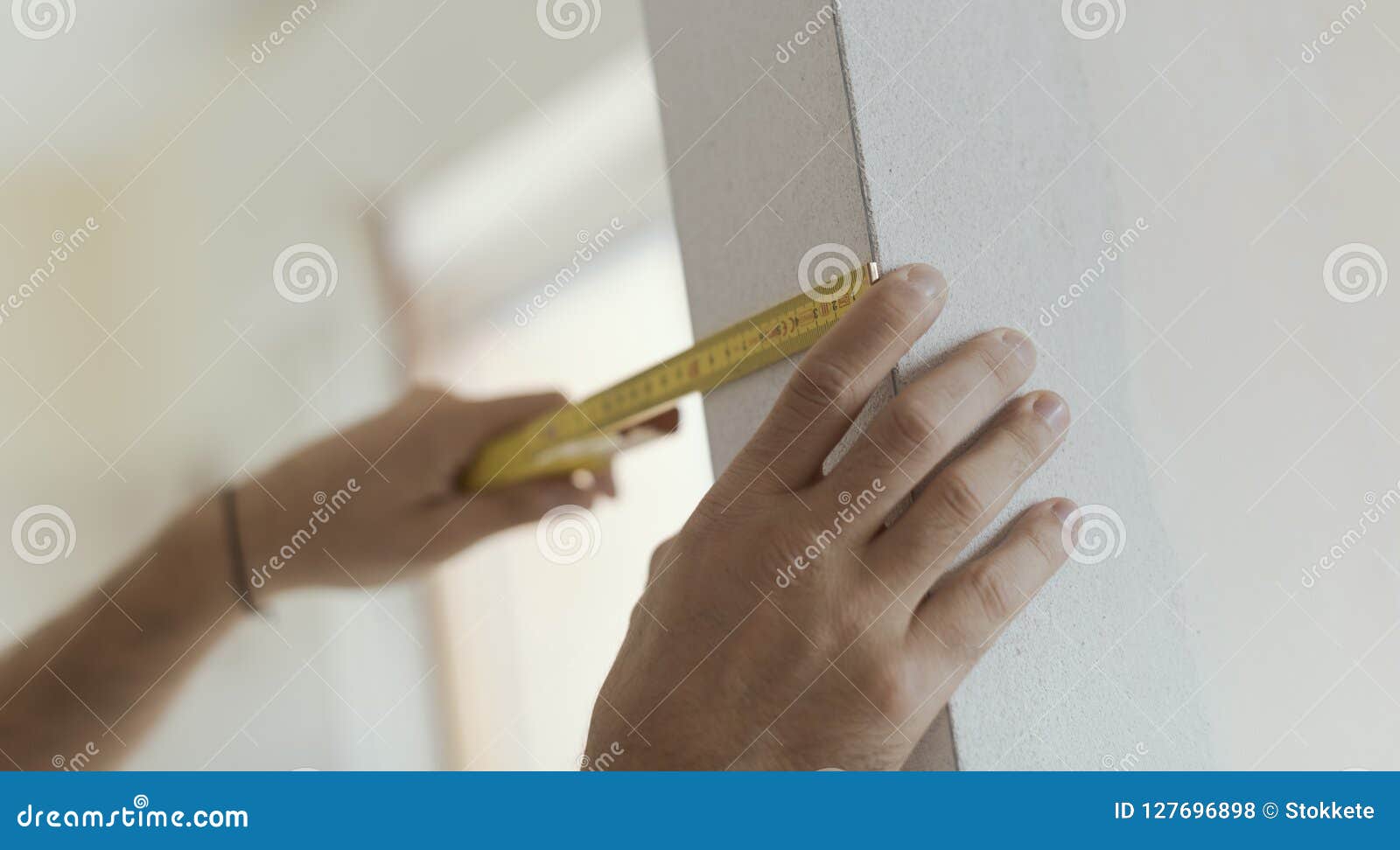 Man Measuring a Wall Using a Folding Ruler Stock Photo - Image of ...