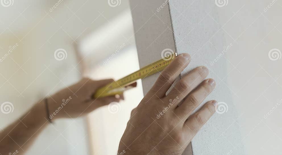 Man Measuring a Wall Using a Folding Ruler Stock Photo - Image of ...