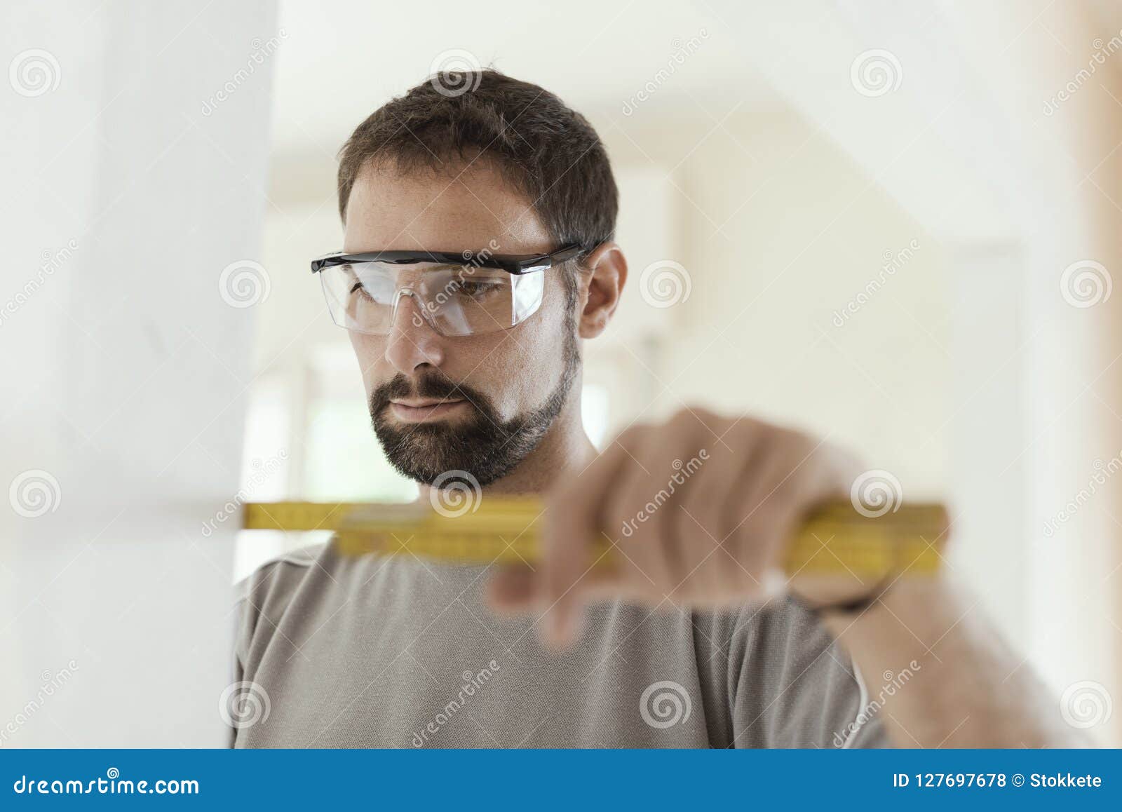 Man Measuring a Wall Using a Folding Ruler Stock Photo - Image of ...